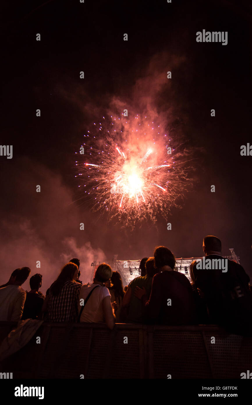 Firework display over buildings in city at night Stock Photo - Alamy