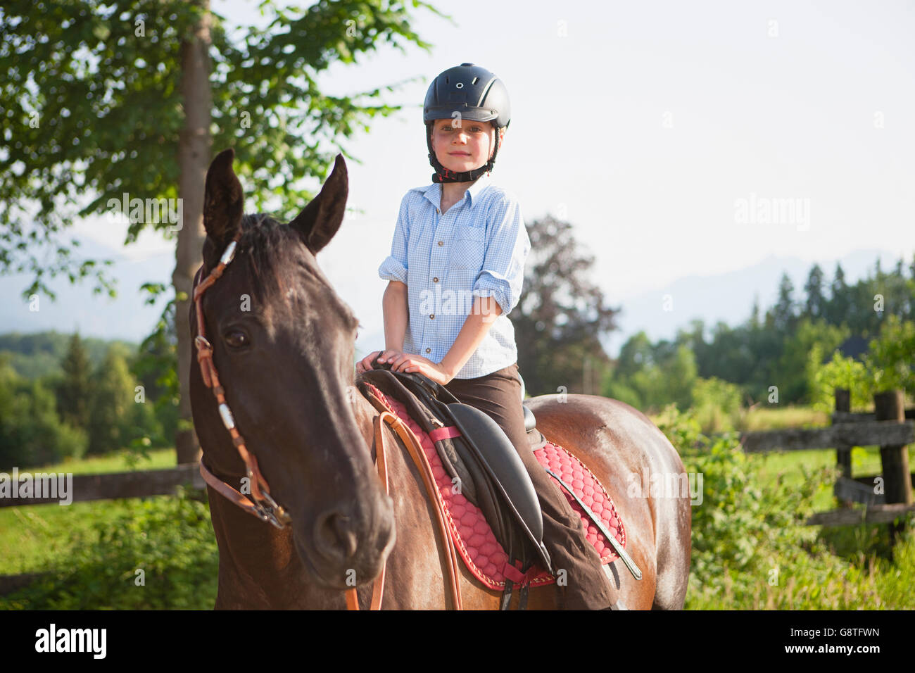Boy horse riding helmet hi-res stock photography and images - Alamy