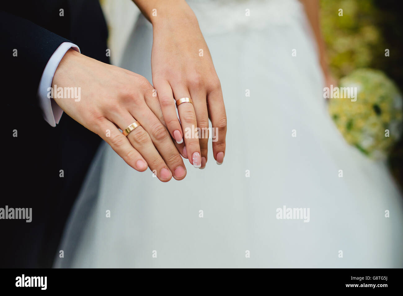 Closeup newly weds show their wedding rings Stock Photo - Alamy