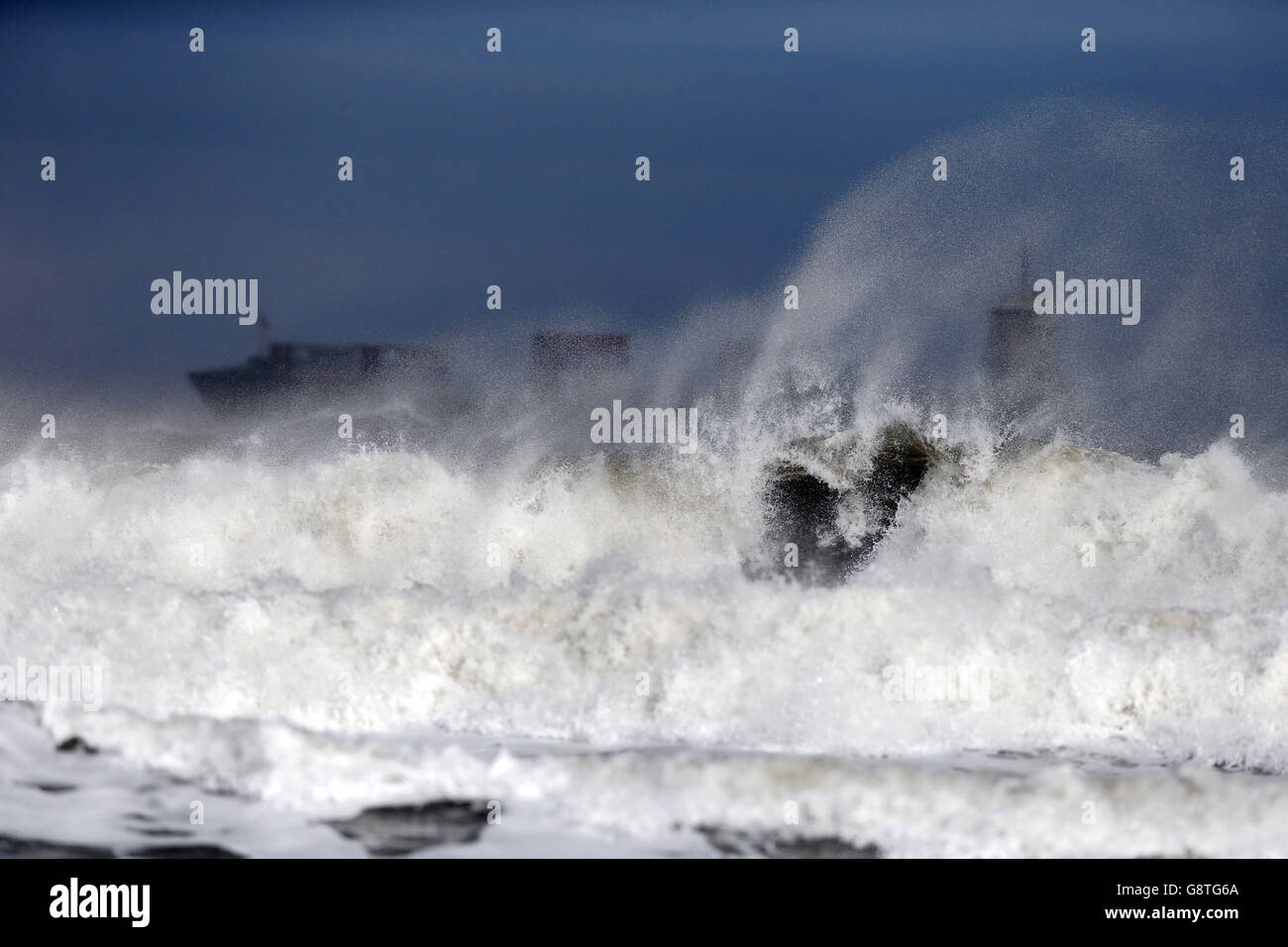 A surfer rides the waves at Tynemouth, Tyne and Wear, North Tyneside ...