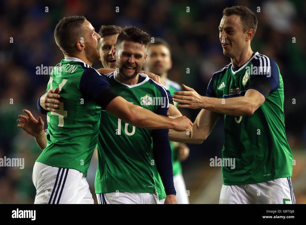 Northern Ireland's Conor Washington (left) celebrates scoring his side ...