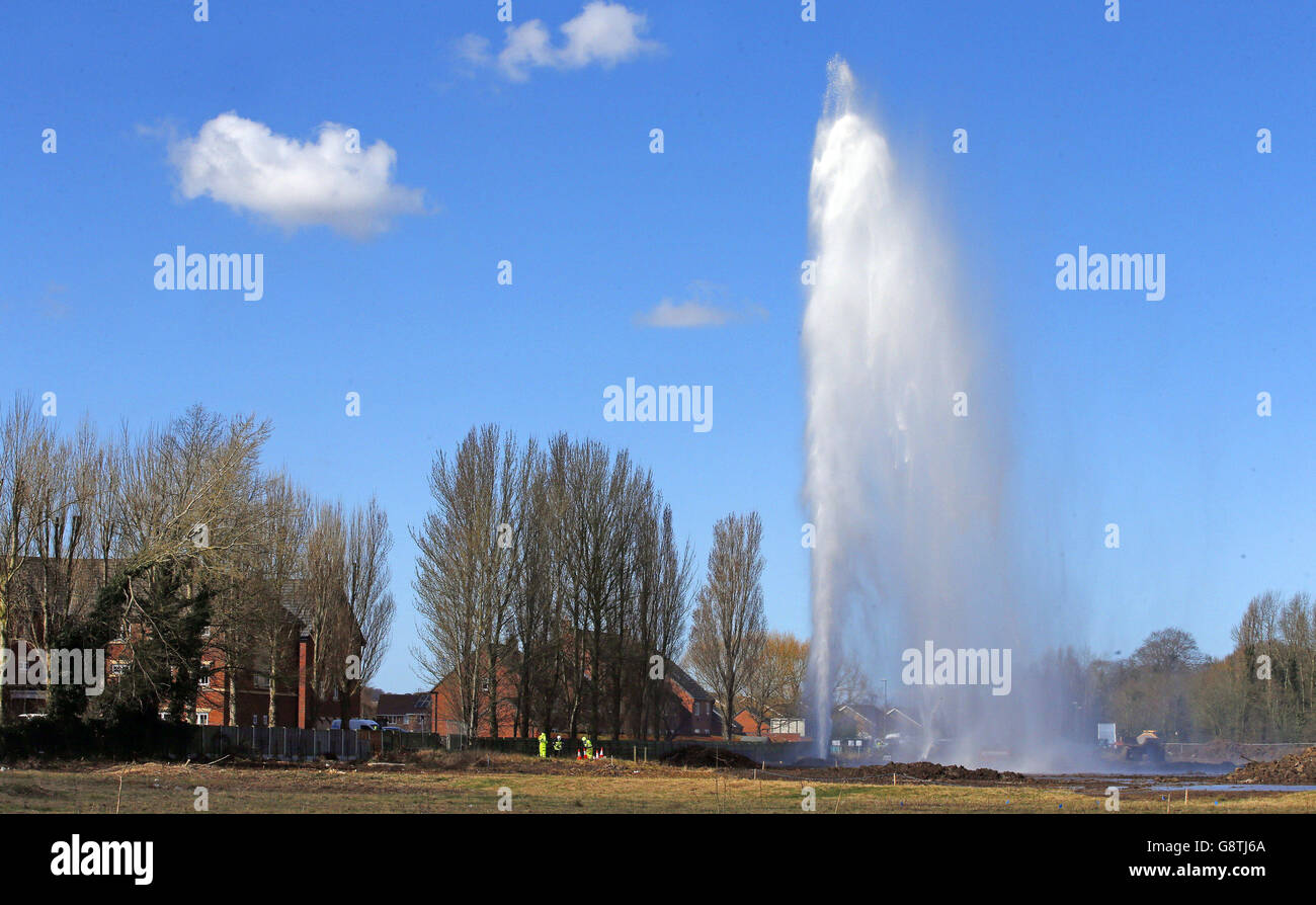 Burst water main. A burst water main on a building site sprays water ...