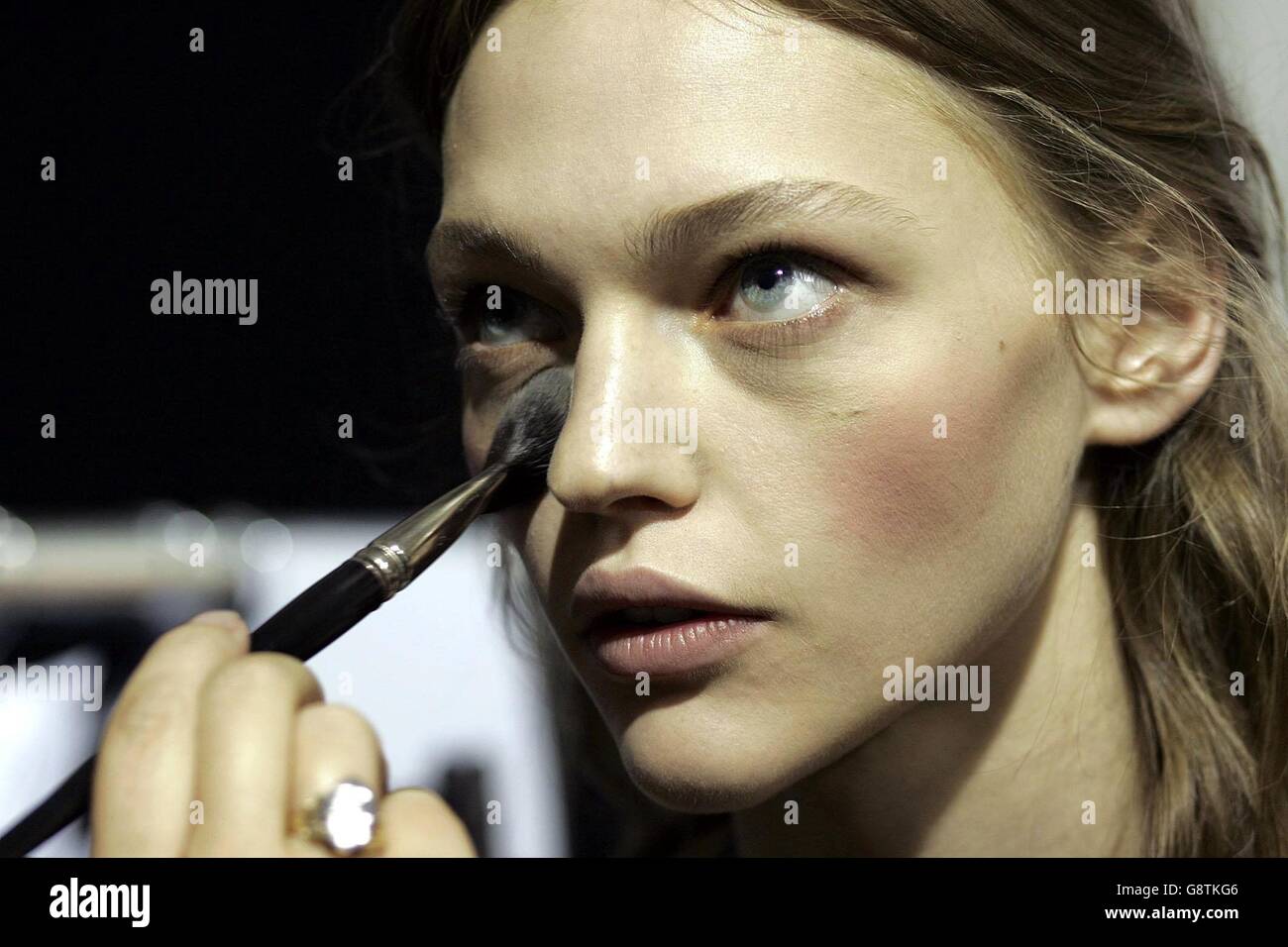 A model is prepared backstage for designer Emma Cook's London Fashion ...
