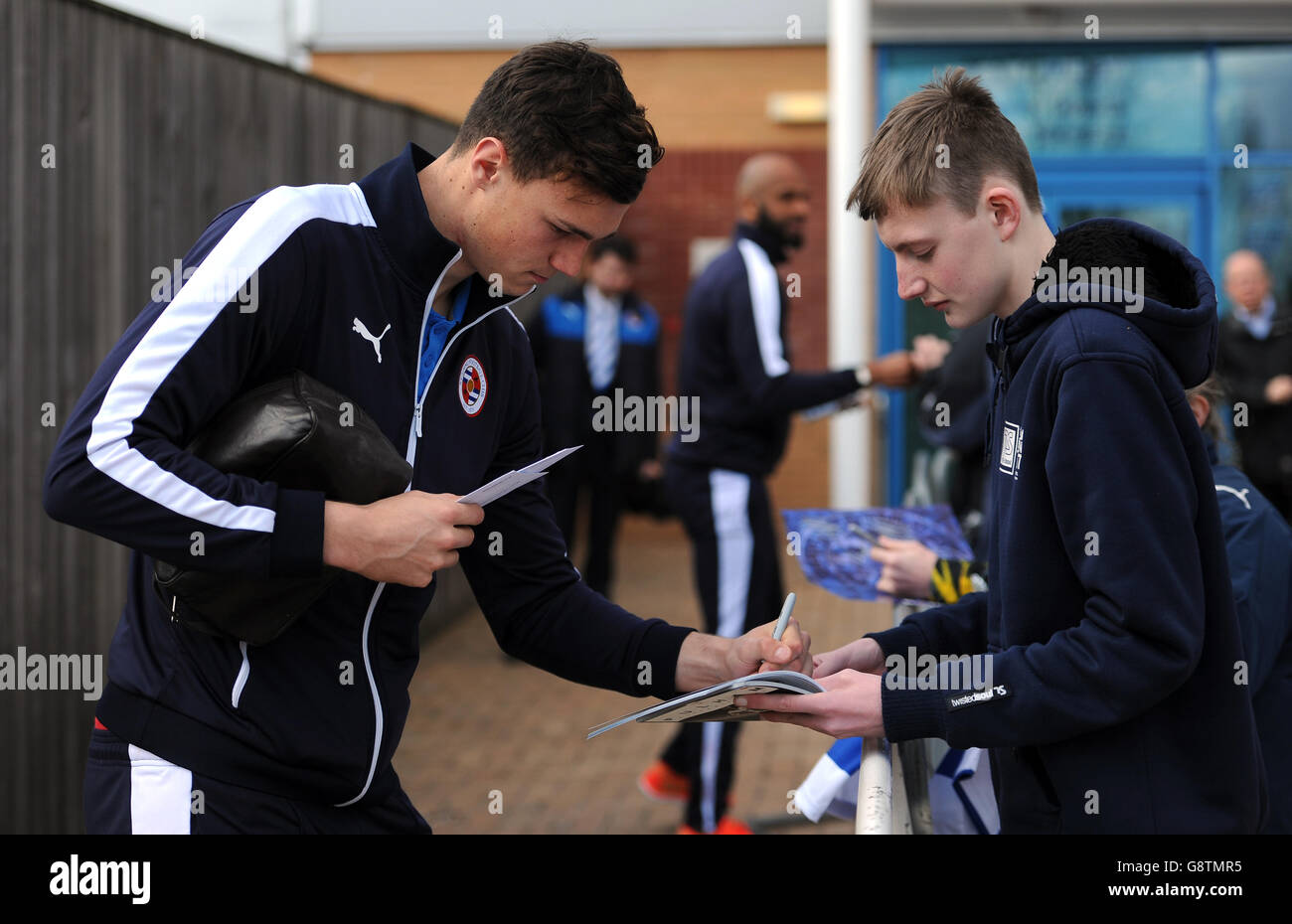 Reading's Jake Cooper (left) signs autographs for fans before kick off ...