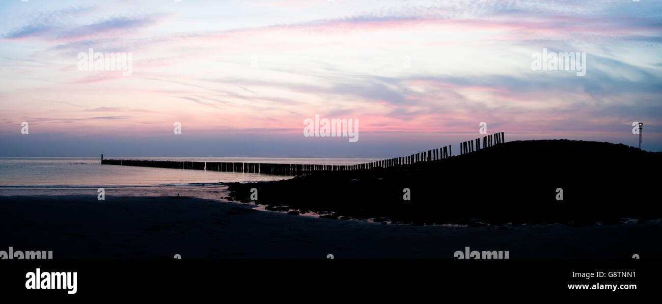 Sunset scene of revealed piers with evening tide in Zeeland region of ...
