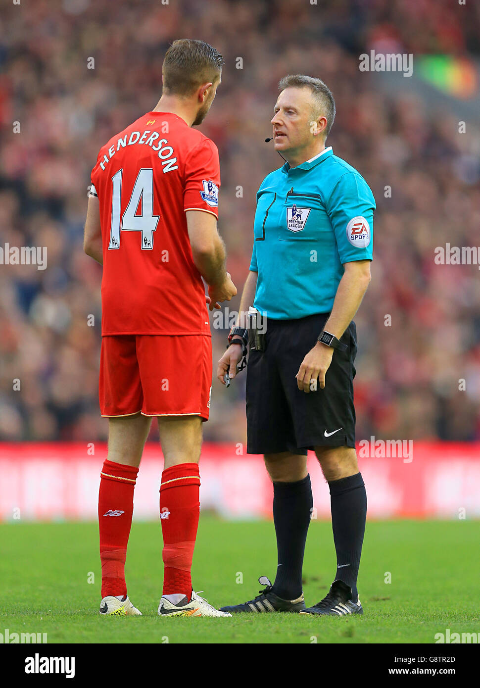 Referee Jon Moss speaks with Liverpool's Jordan Henderson Stock Photo ...