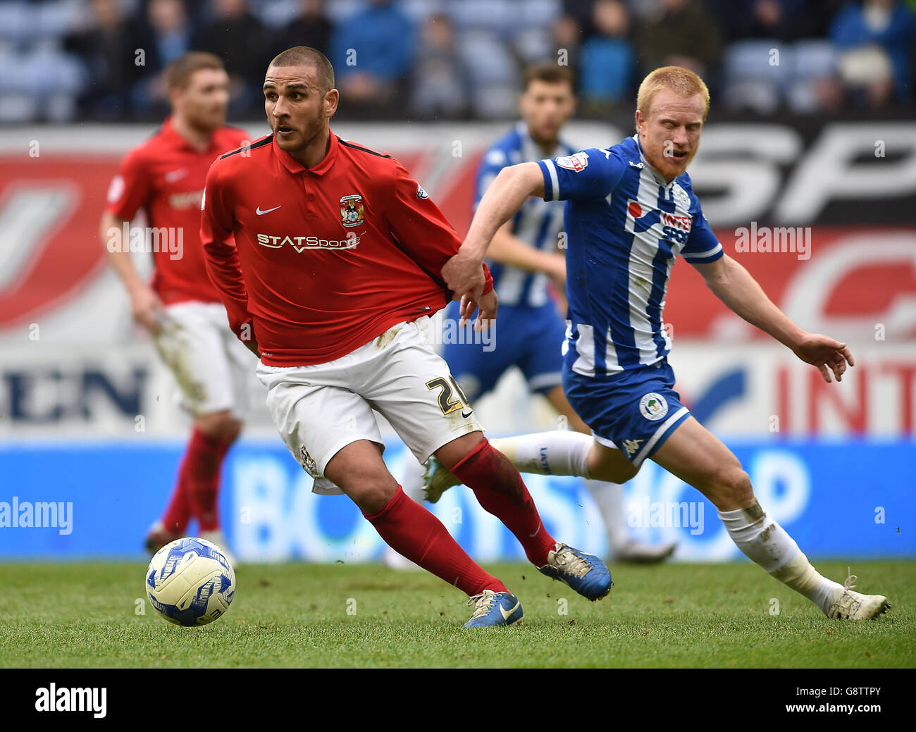 Coventry City forward Marcus Tudgay is challenged by Wigan Athletic ...