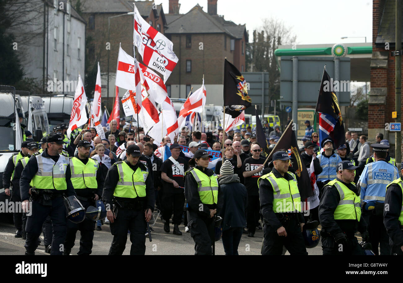 Police officers march with a group of far-right protesters in Dover ...