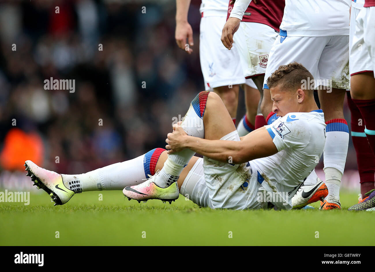 Crystal Palace's Dwight Gayle holds his leg after a challenge during ...