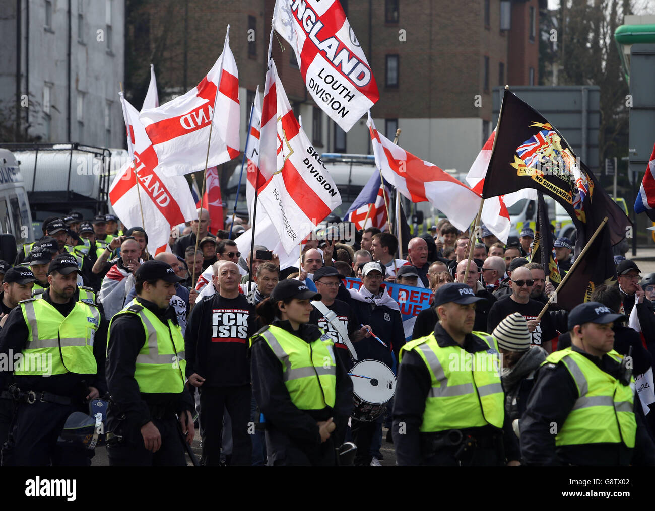 Police officers march with far-right protesters though Dover in Kent as ...