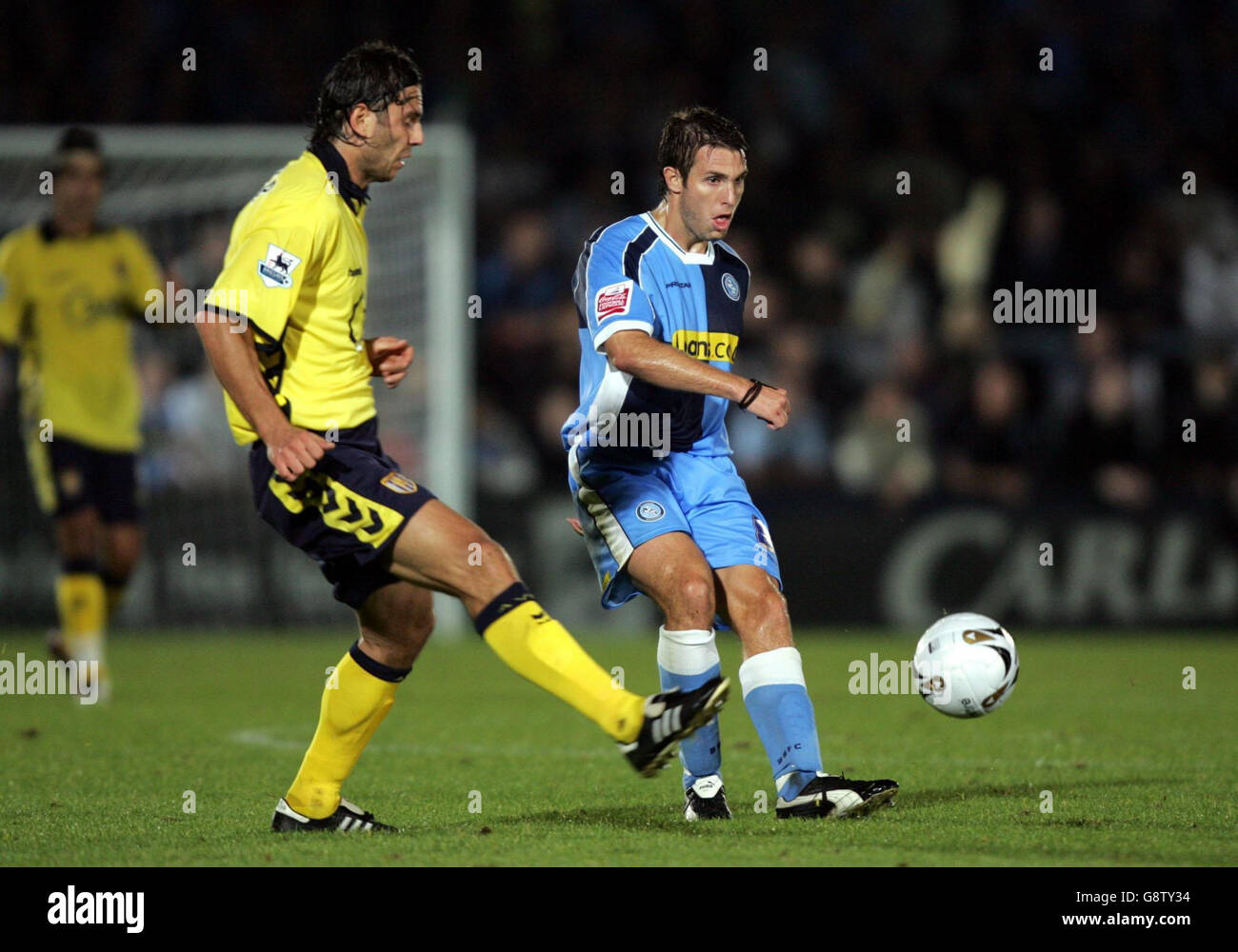 Wycombe's Joe Burnell (R) passes under pressure from Aston Villa's ...