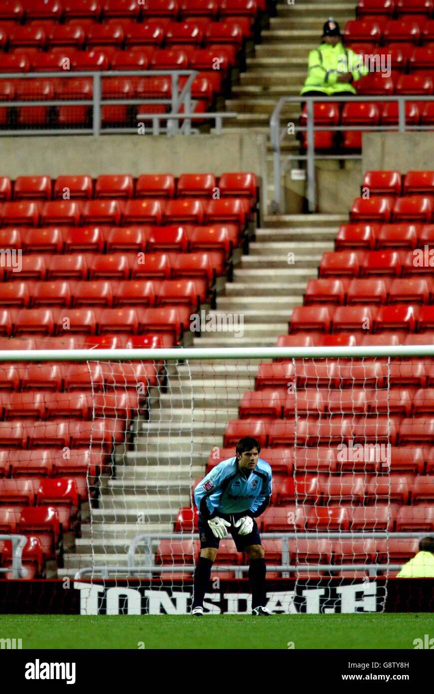 Cheltenham Town's keeper Shane Higgs plays in front of an empty stand ...