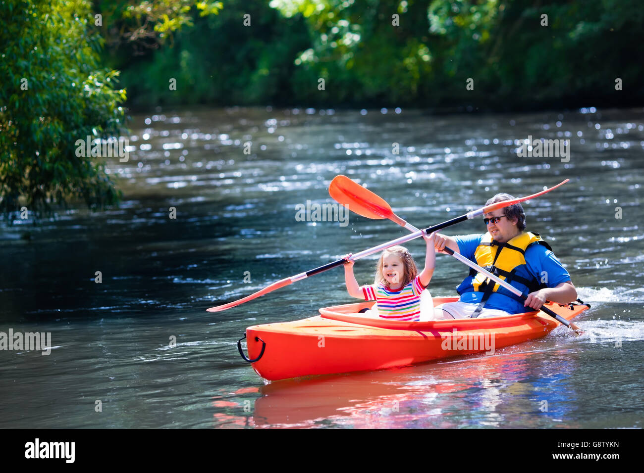 Family on kayaks and canoe tour. Father and child paddling in kayak in ...
