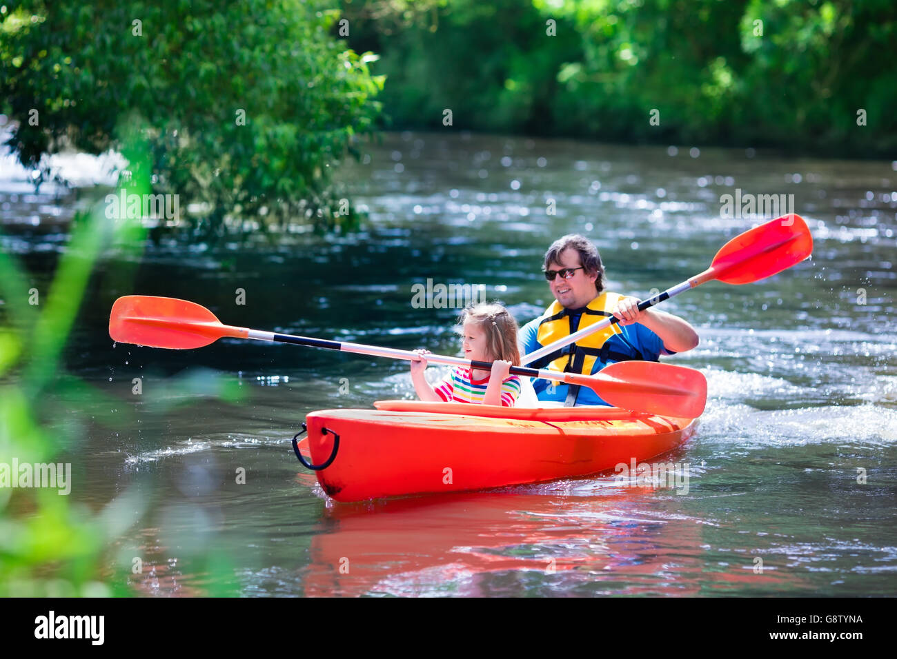 Family on kayaks and canoe tour. Father and child paddling in kayak in ...
