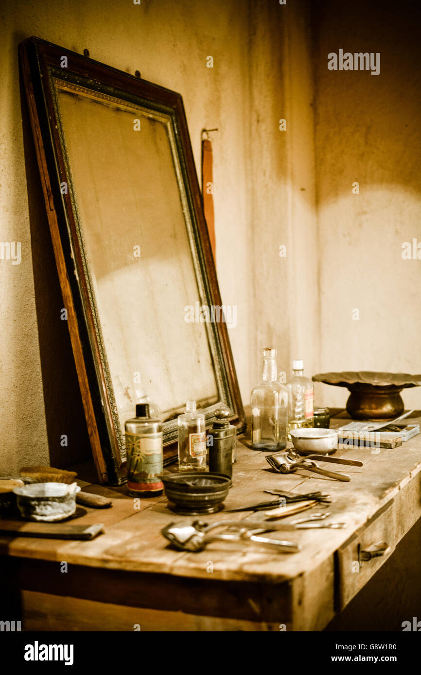 Tools and mirror on messy table in old room hi-res stock photography ...