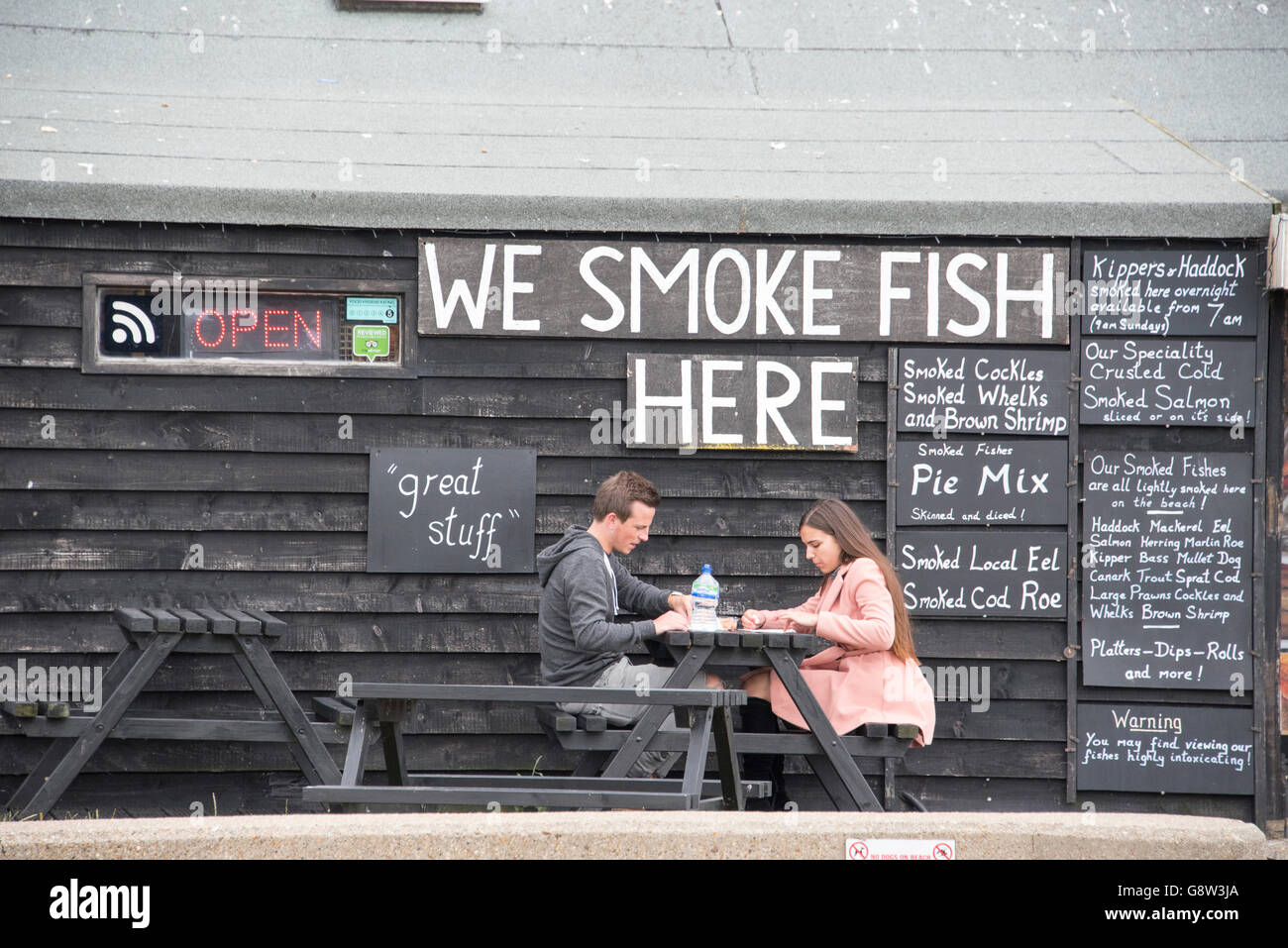 Man and woman eating fish and chips Stock Photo - Alamy