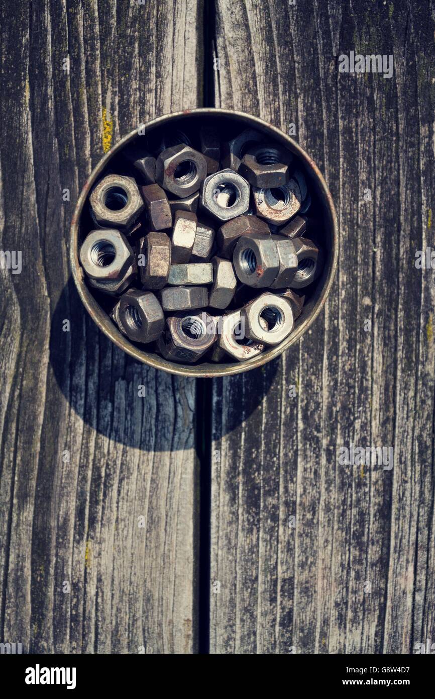 Nuts in a tin can on wooden board background Stock Photo - Alamy