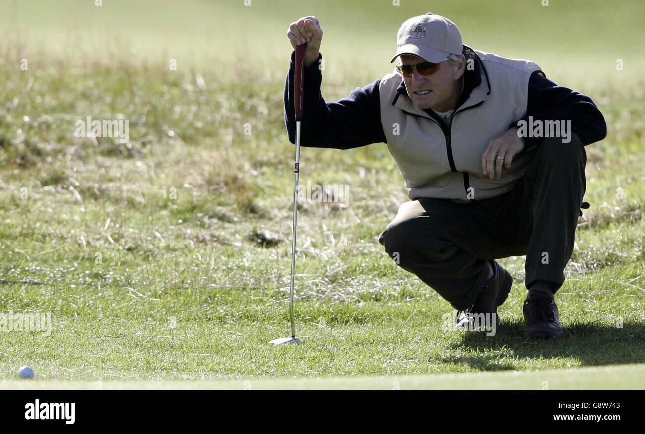 Actor Michael Douglas lines up a putt during a practise round on the ...