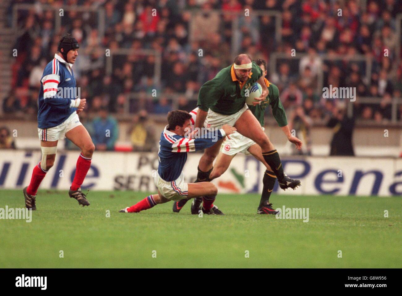South africas mark andrews right breaks through a french tackle hi-res ...