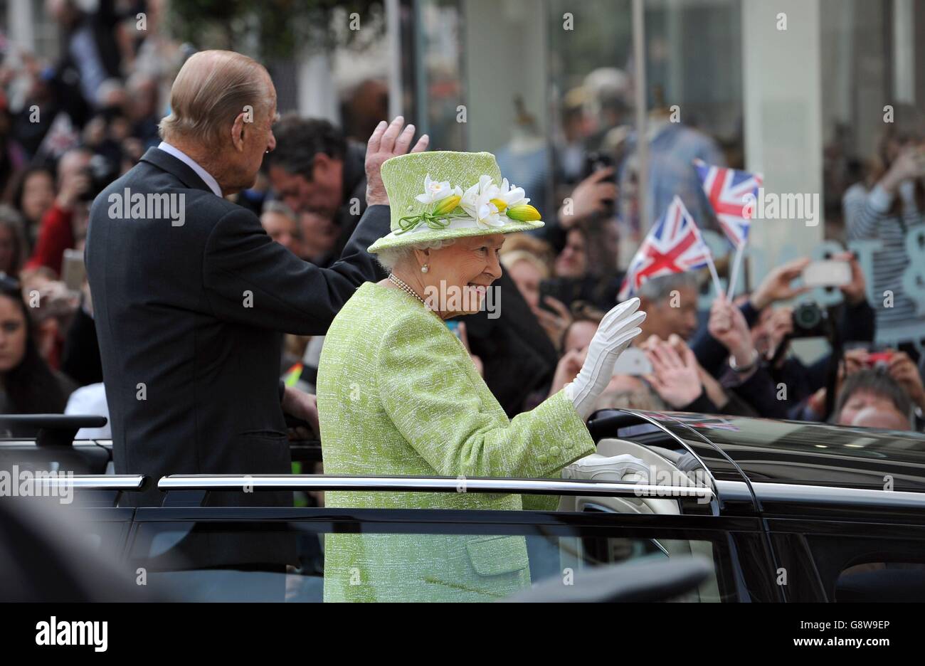 Queen Elizabeth II and the Duke of Edinburgh wave to well wishers from ...