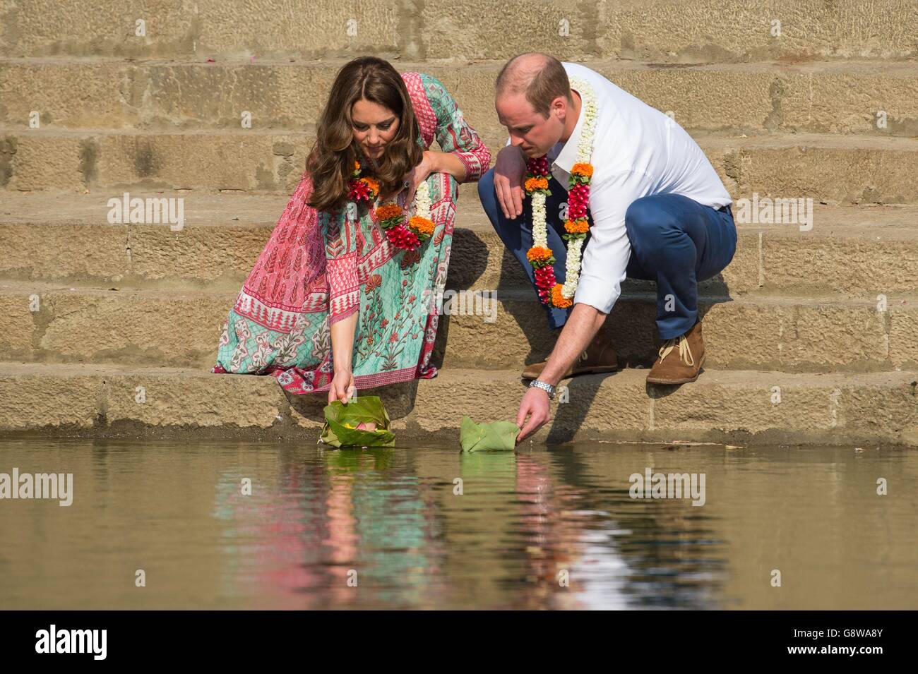The Duke and Duchess of Cambridge place flower petals in the water of ...