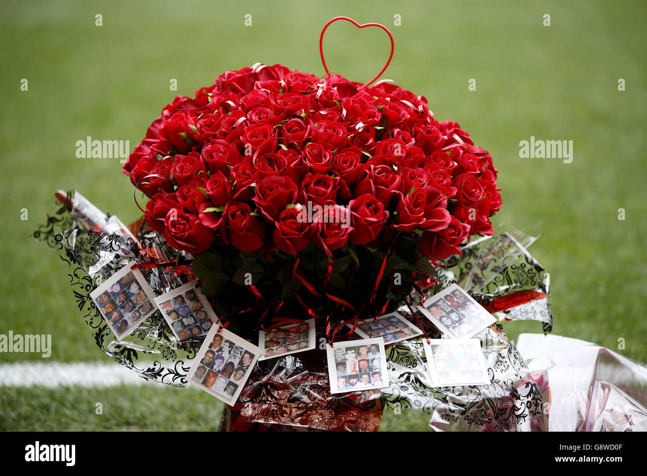 Roses are placed on the side of the pitch at Anfield during the ...