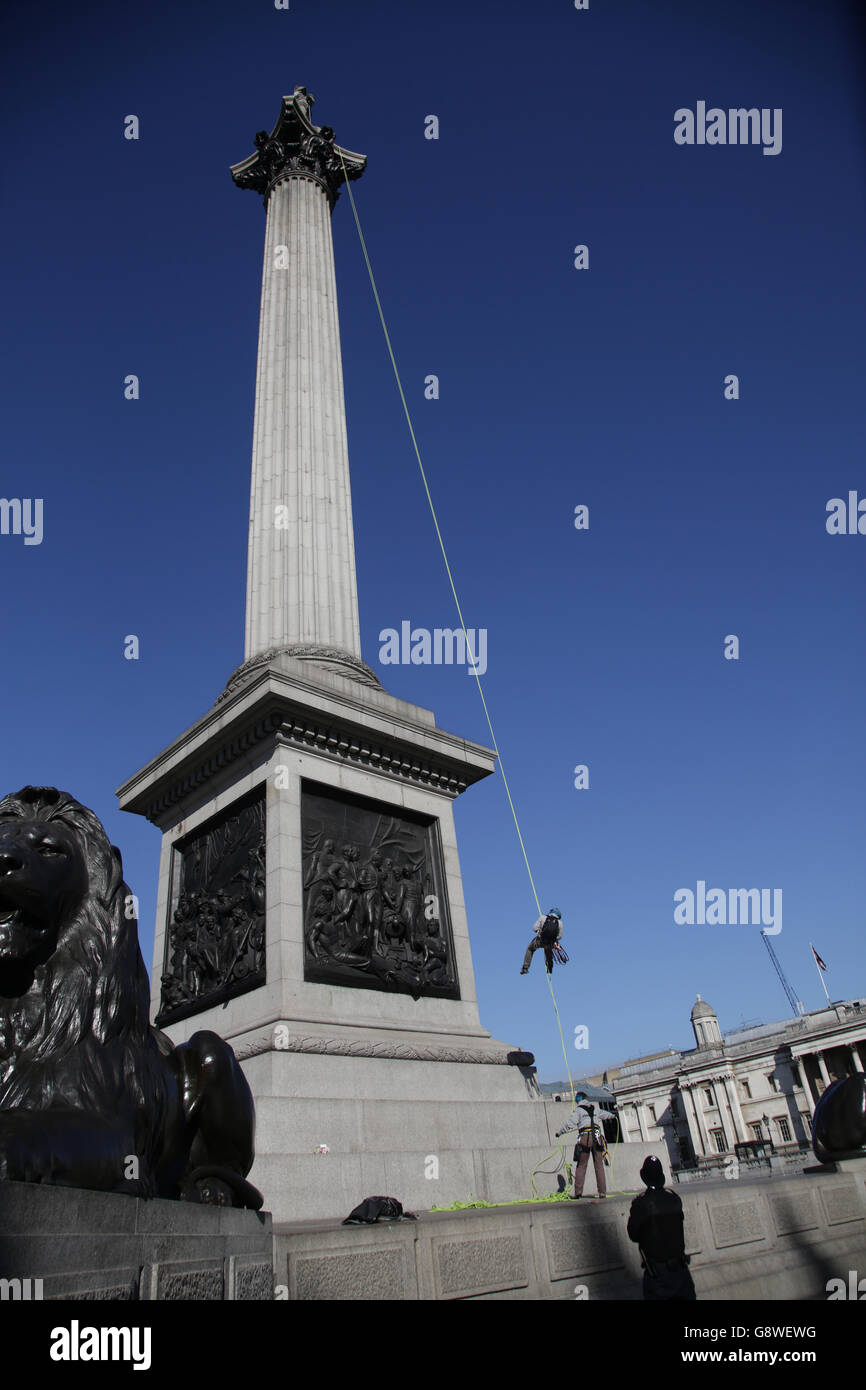 s Trafalgar Square to place a mask on the statue of Lord Nelson as part ...