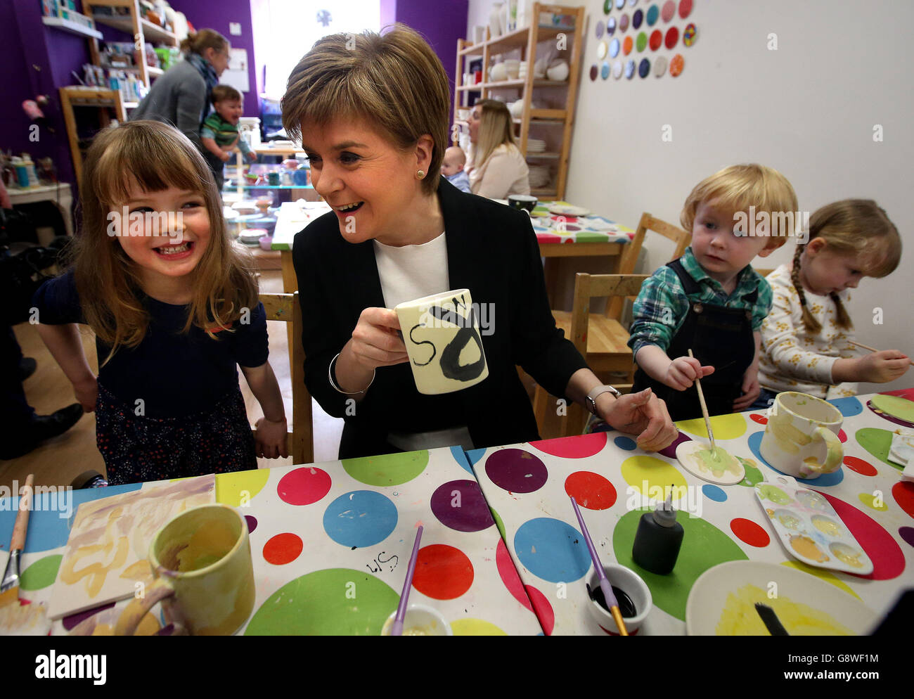 SNP leader Nicola Sturgeon painting mugs with Freya Finnie (left) and ...