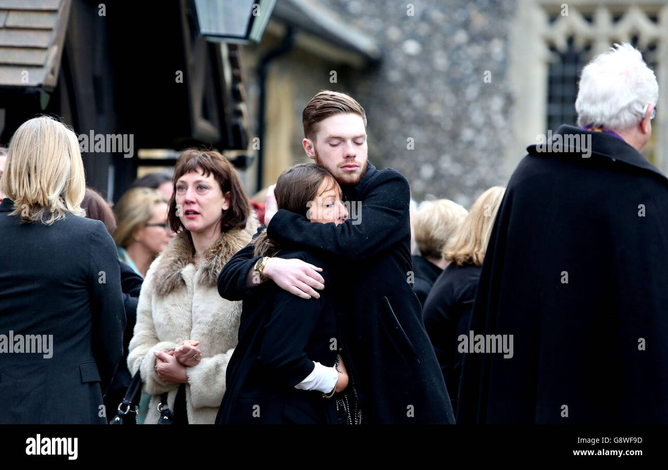Mourners comfort each other as they leave St John the Evangelist Church ...