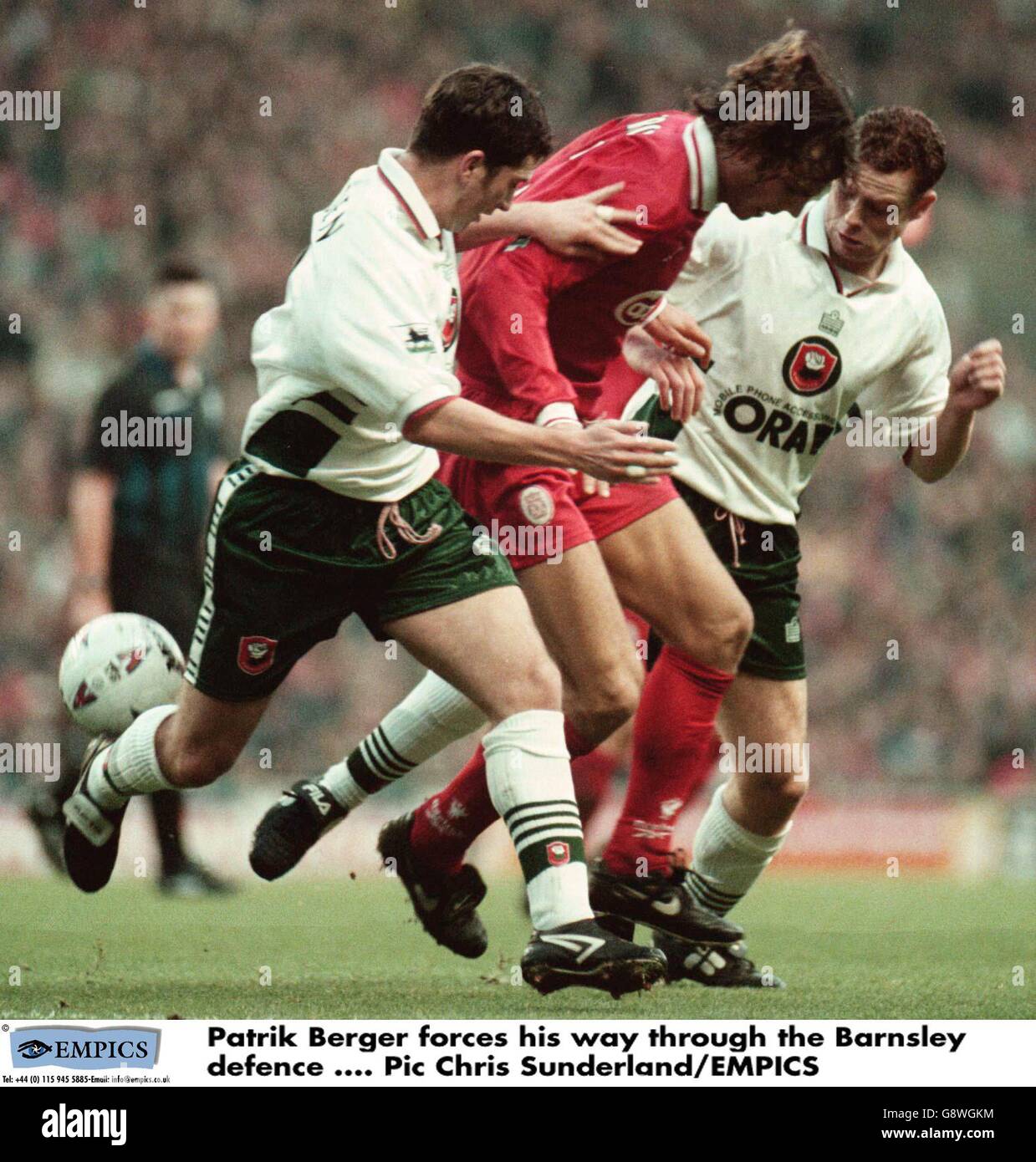 Liverpool's Patrik Berger tries to forces his way between Barnsley's ...