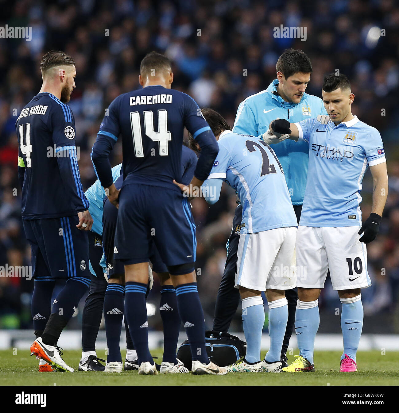 Manchester City's Sergio Aguero speaks to the physio complaining of a ...
