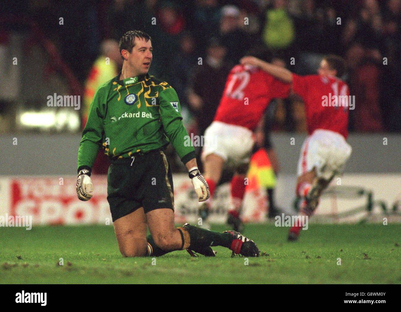 Leeds United goalkeeper Nigel Martyn (left) looks for a sign of his ...