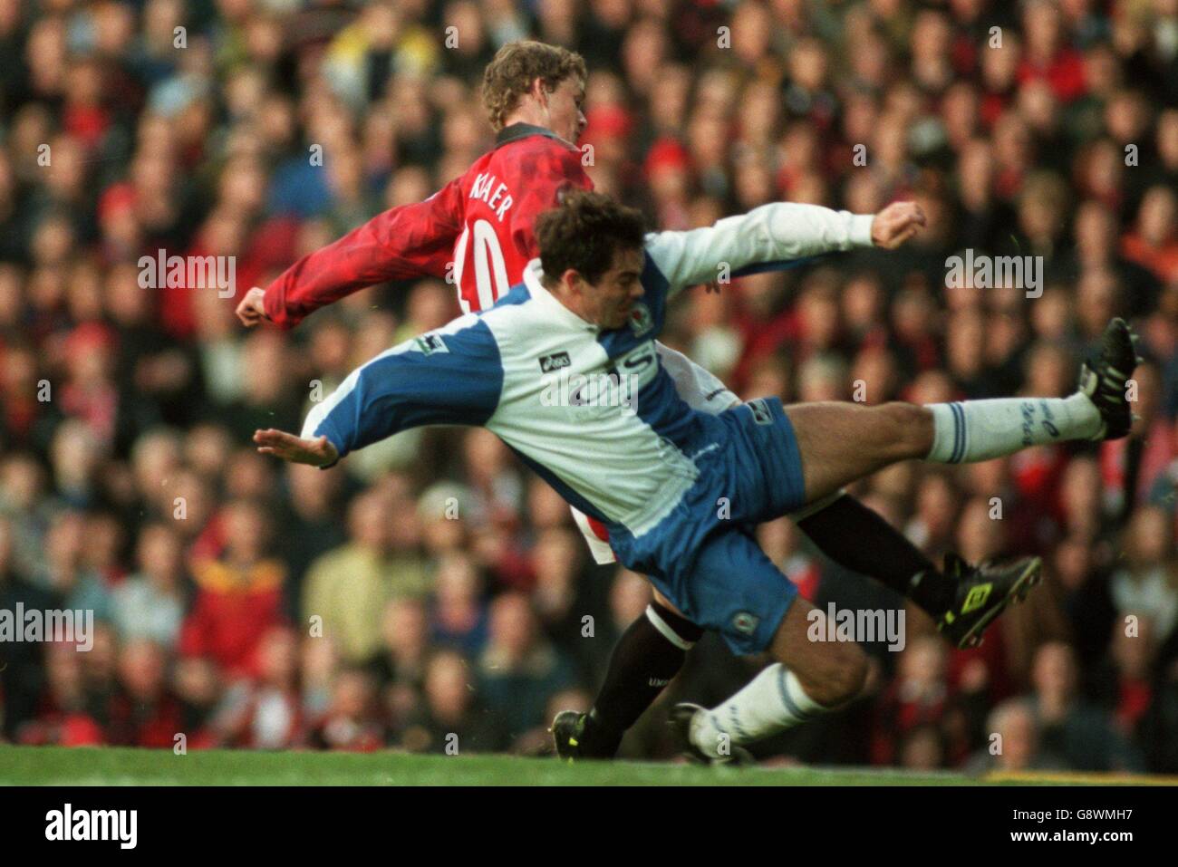 Jeff Kenna of Blackburn Rovers (front) is unable to prevent Ole Gunnar ...