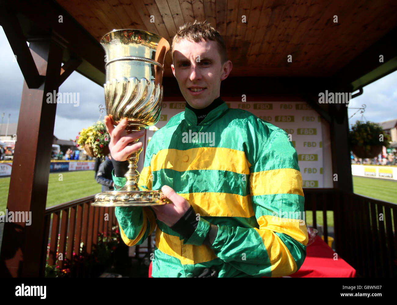 Jockey Mark Walsh with the trophy after his winning ride on ...