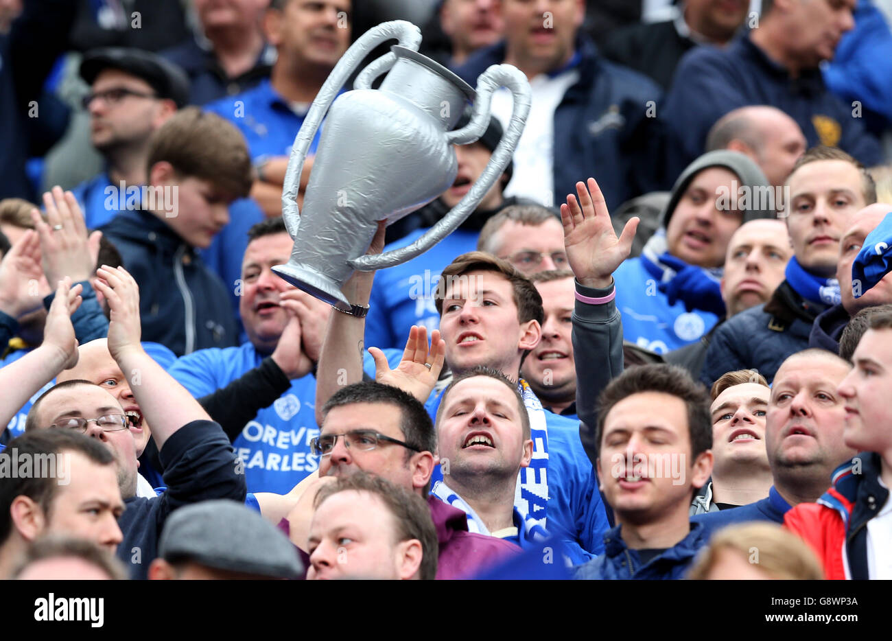 A Leicester City fan waving a inflatable Premier League trophy during ...