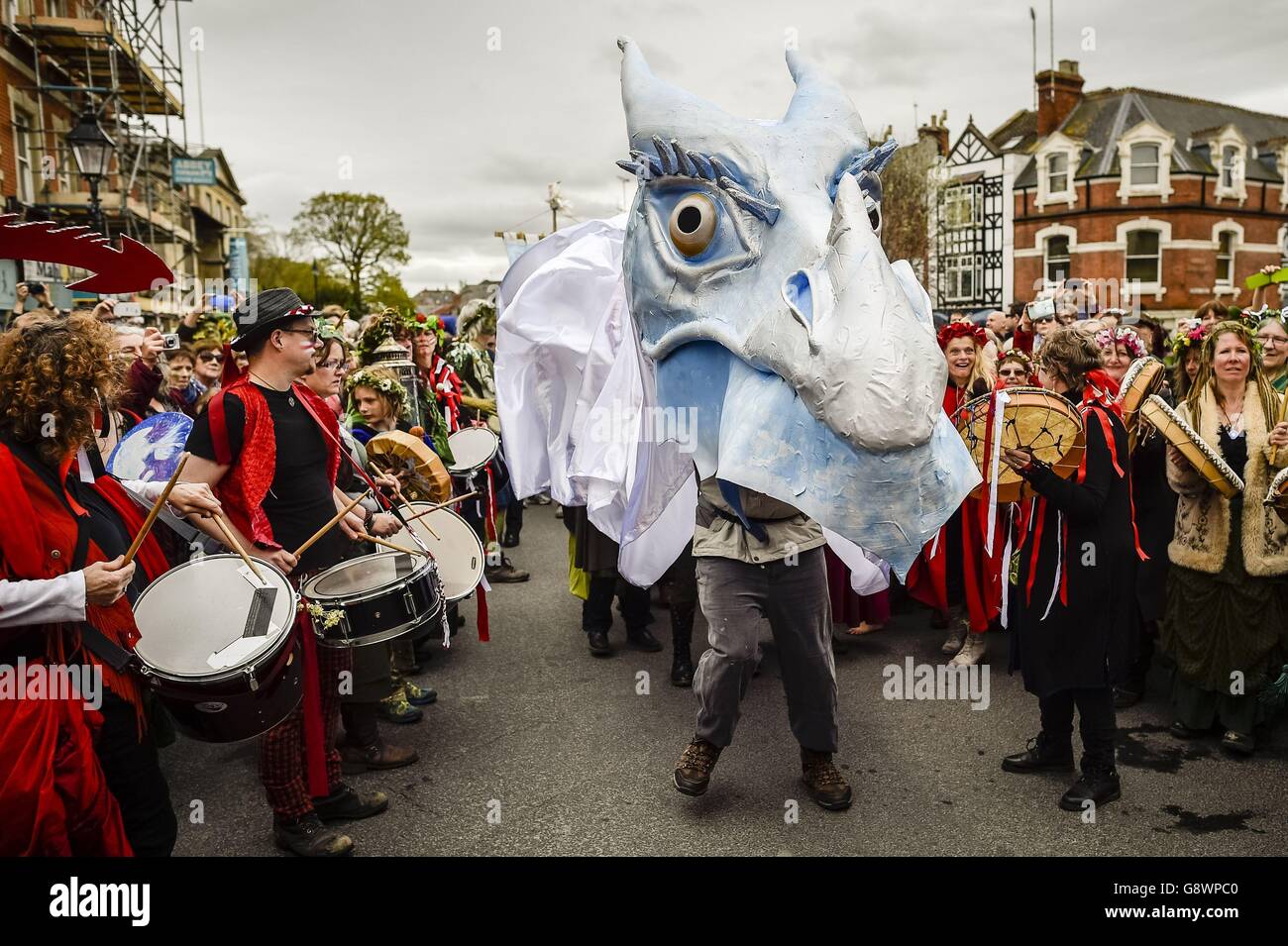 A white dragon costume proceeds through the crowds during the ...