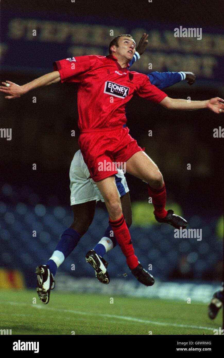Dean Blackwell of Wimbledon (front) jumps with Leicester City's Emile ...