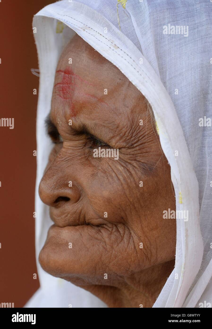 A villager awaits the arrival of the Duke and Duchess of Cambridge in ...