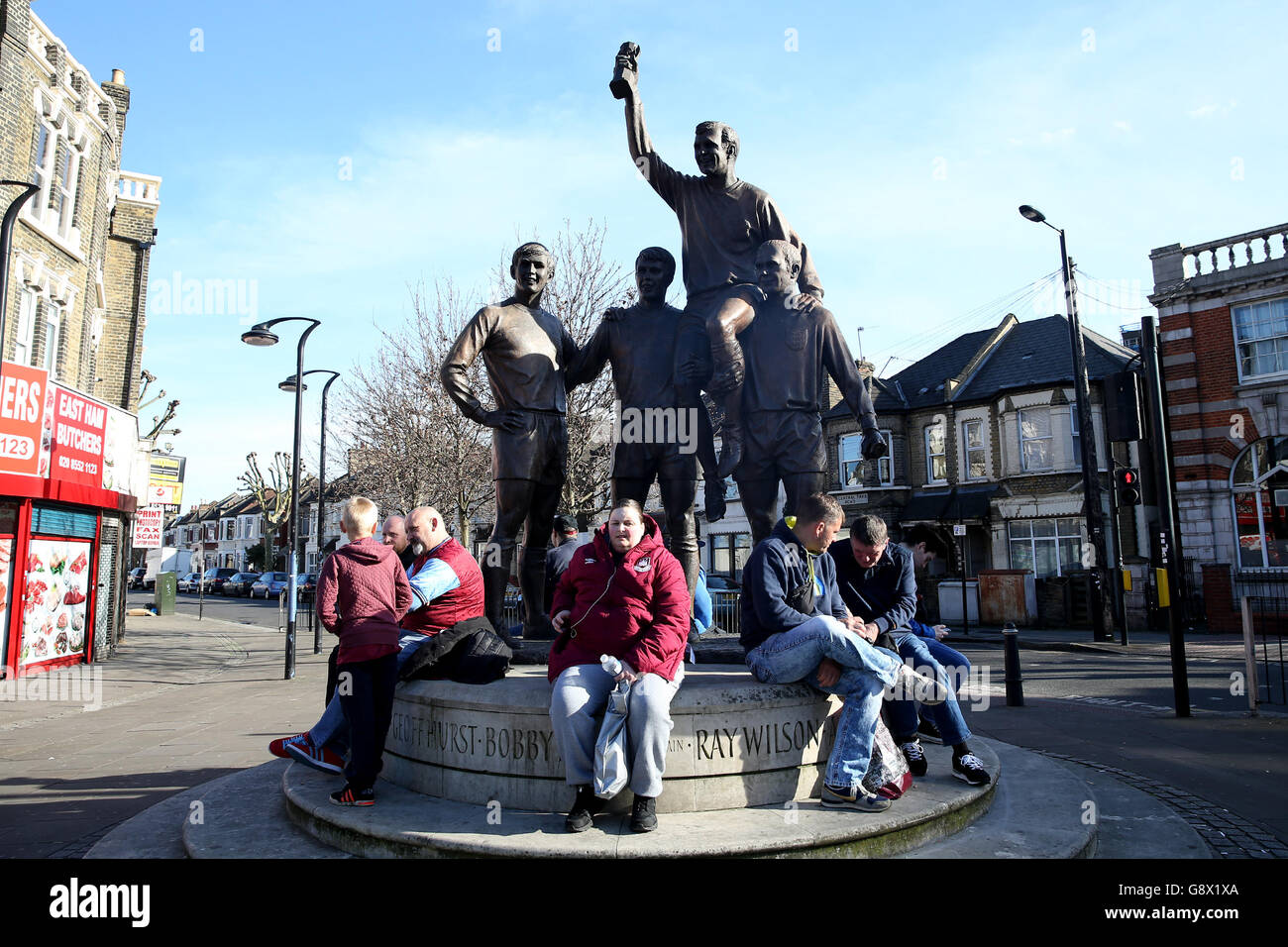 Fans gather around statue outside upton park featuring bobby moore hi ...