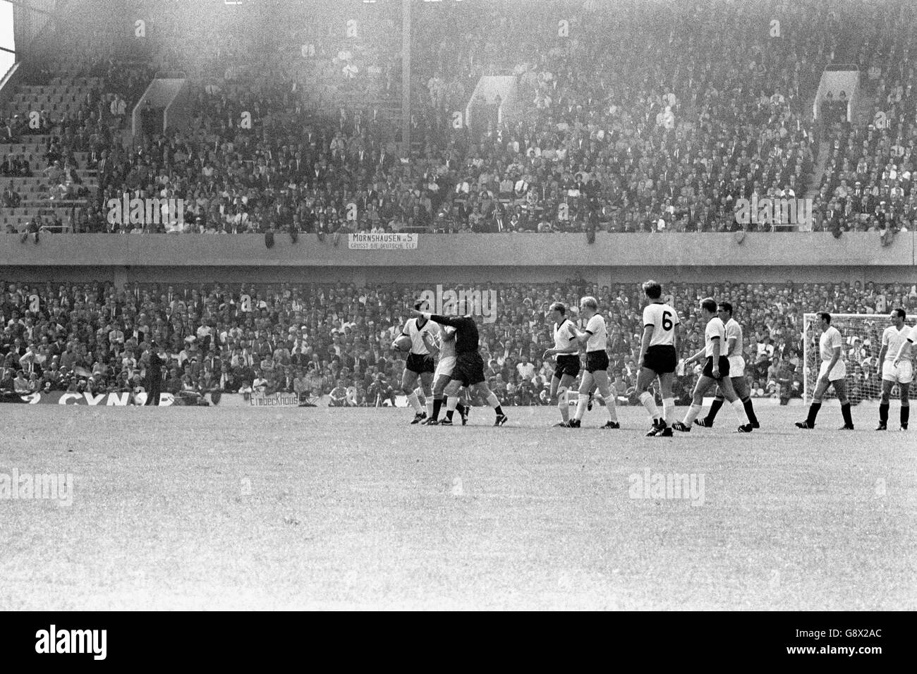 Referee Jim Finney (third l) marches Uruguay's Horacio Troche (second l ...