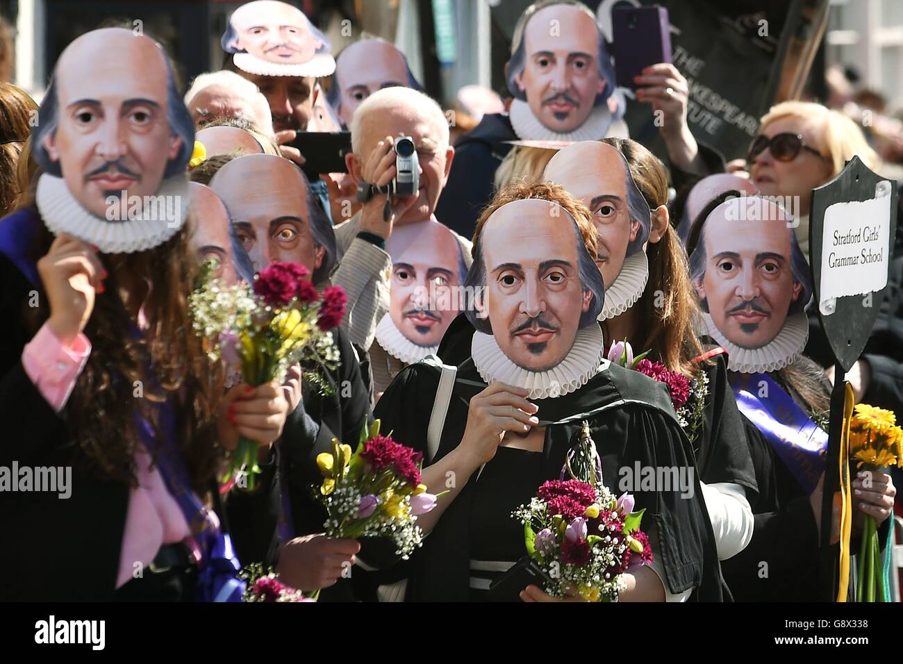Members of the public wear William Shakespeare masks during the parade ...