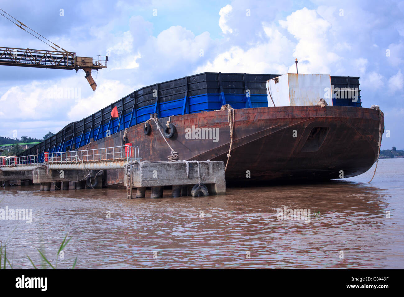 Standby barge at jetty Stock Photo - Alamy