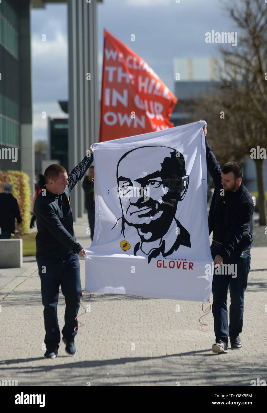 Two men hold a banner honouring Hillsborough campaigner John Glover as ...