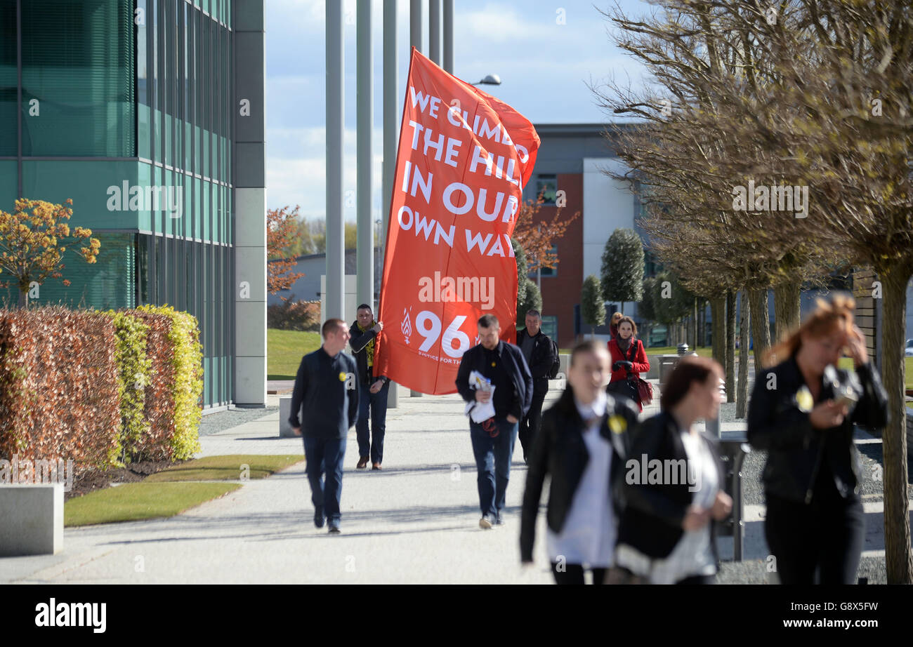 Two men hold a Justice for the 96 banner as they arrive at the ...