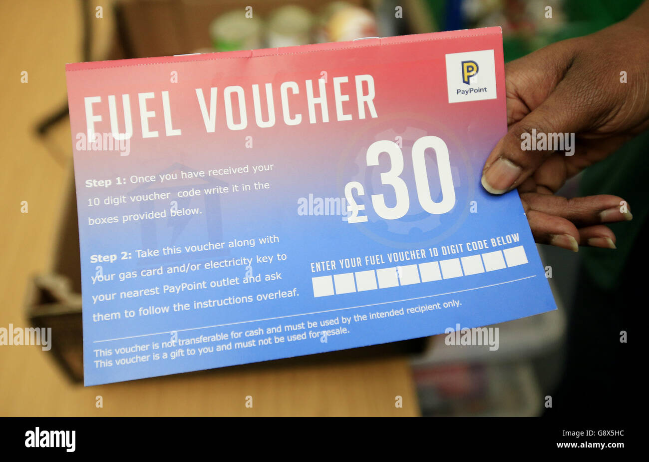 Centre manager Michele Lawrence gives a fuel voucher to a client at the ...
