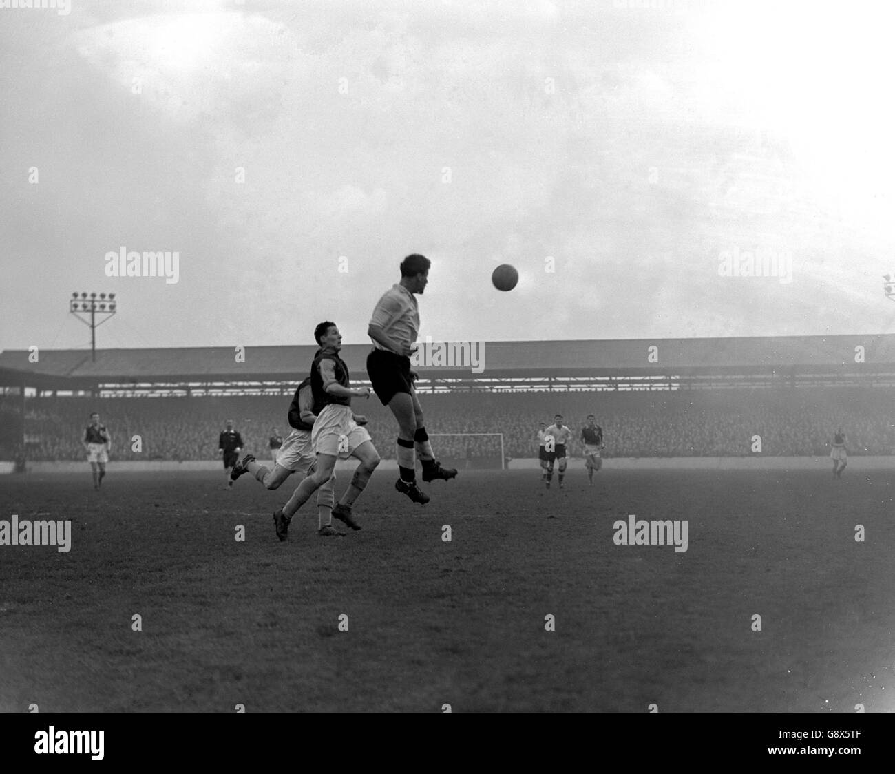 Tommy Dixon of West Ham United (left) and Mel Charles of Swansea in ...