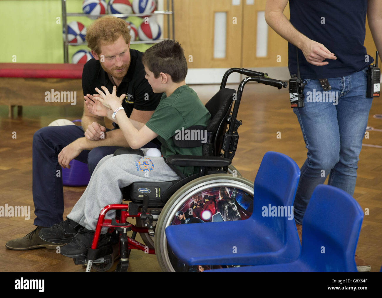 Prince Harry talks with Craig, 10, between segments in the filming of ...
