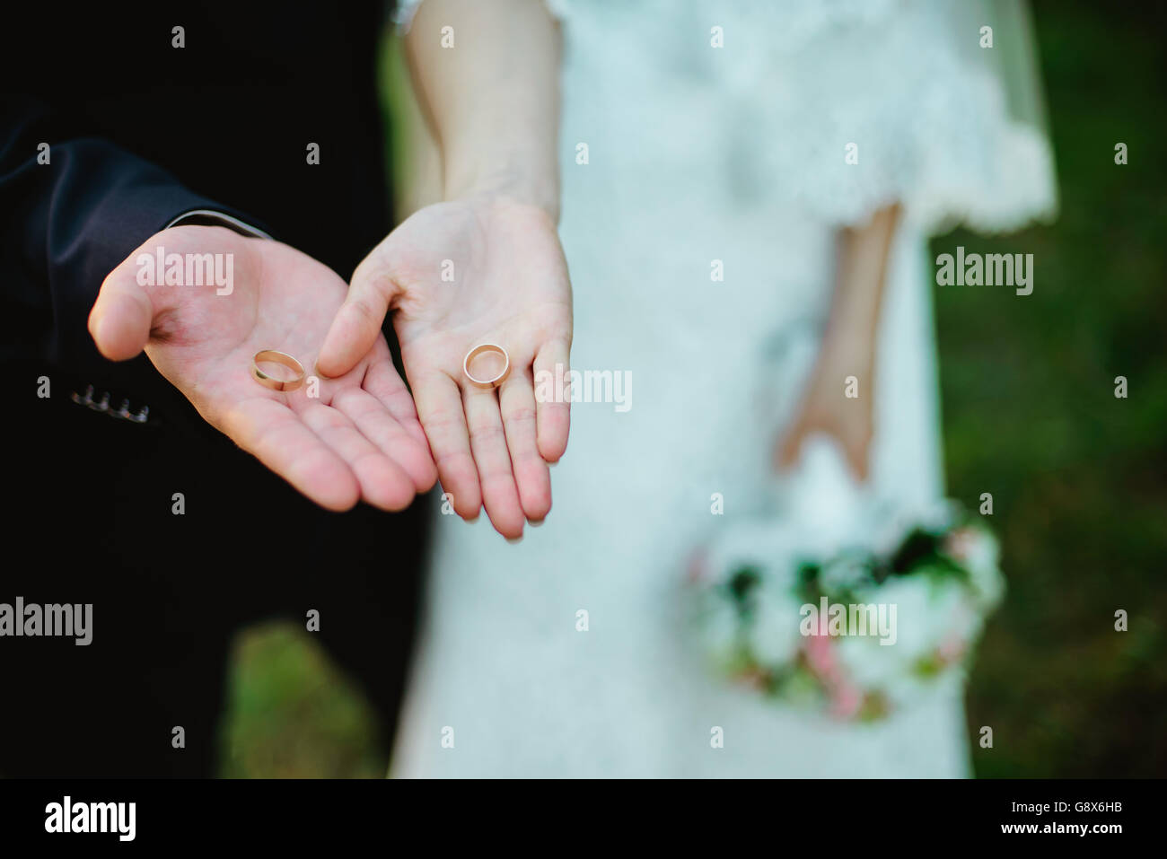 Closeup newly weds show their wedding rings Stock Photo - Alamy