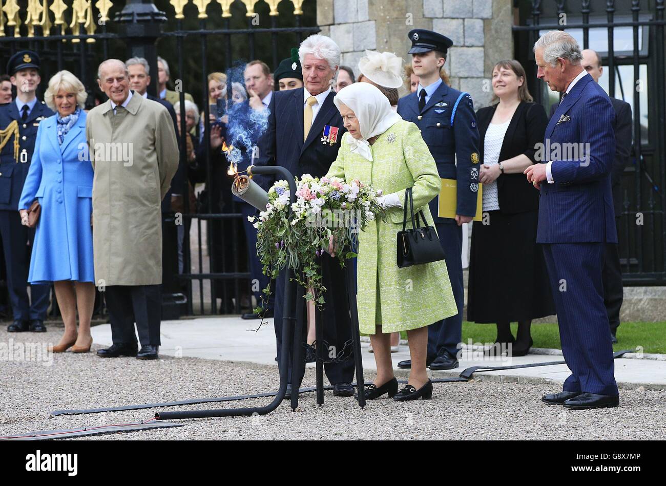 Queen Elizabeth II lights a beacon at Windsor Castle in Berkshire, as ...