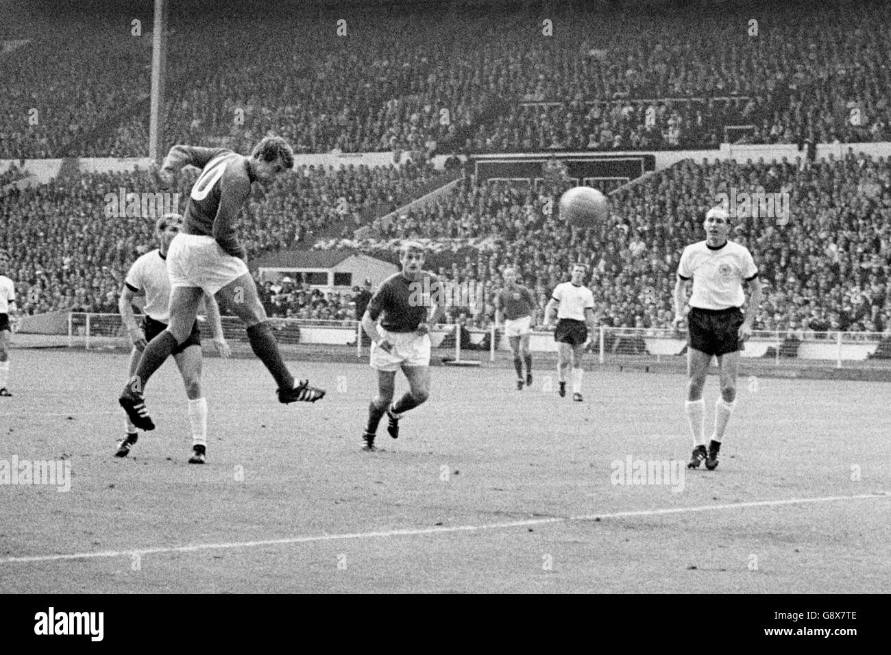 England's Geoff Hurst (second l) heads the equalising goal, watched by ...